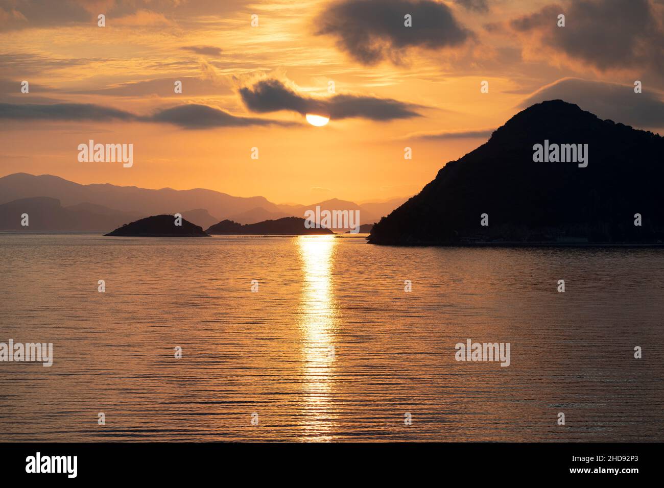 golden sunset over the sea with islands Stock Photo - Alamy