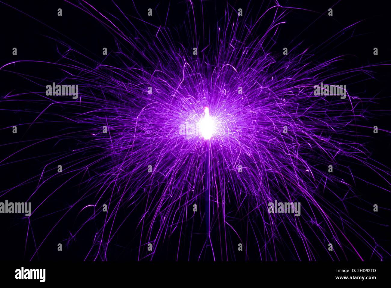 Sparkler, purple sparks on a black background. Abstract photo of sparks ...