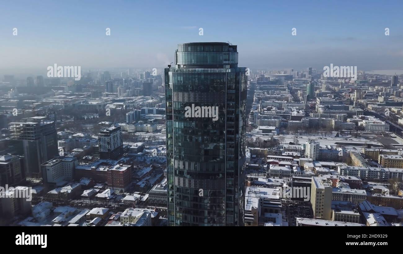 Aerial view of skyscraper is in the middle of the city in winter, blue ...