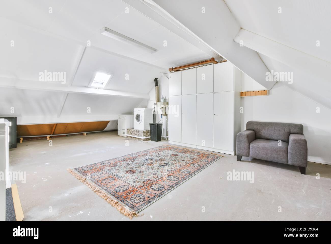 Room with washing machine, dryer and sofa Stock Photo - Alamy