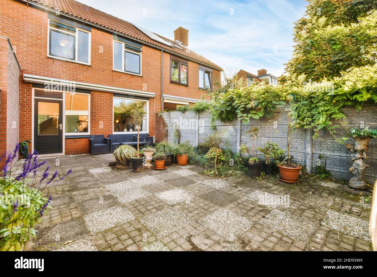 Small courtyard with lots of greenery and brick walls Stock Photo - Alamy