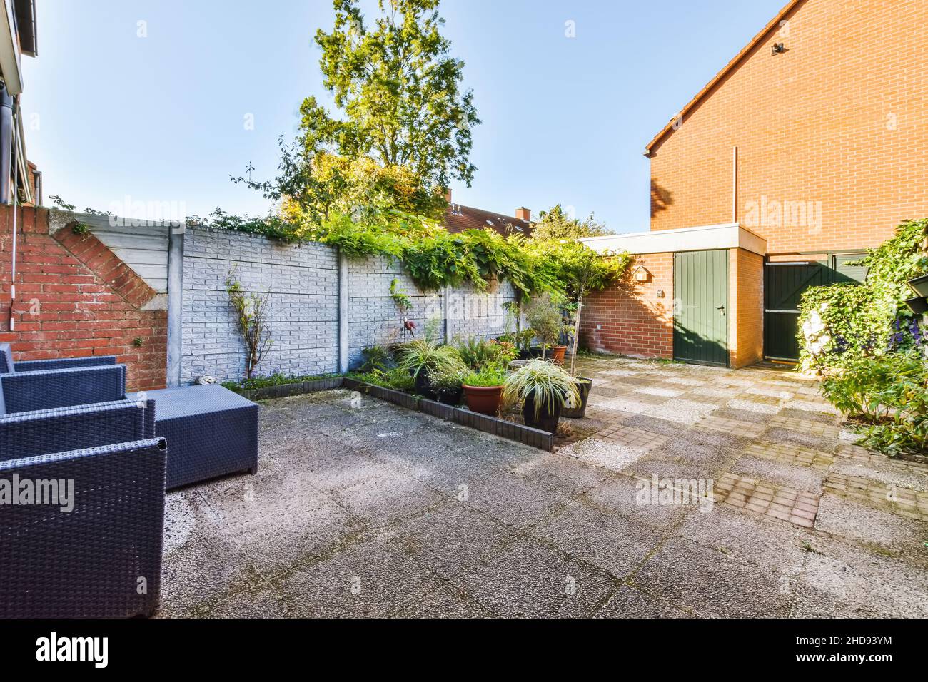 Small courtyard with lots of greenery and brick walls Stock Photo - Alamy