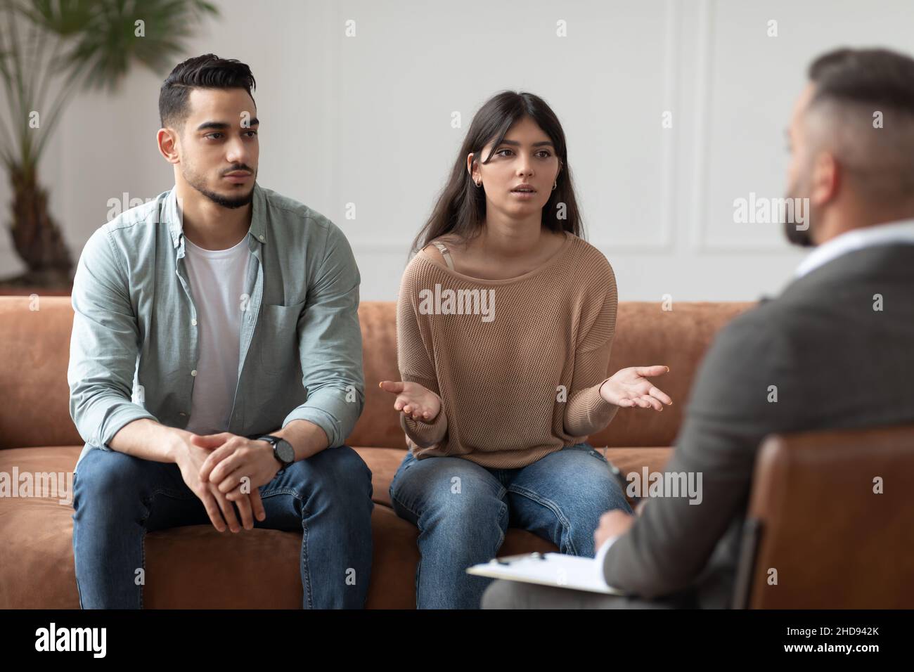 Couple talking at session with professional male therapist Stock Photo ...