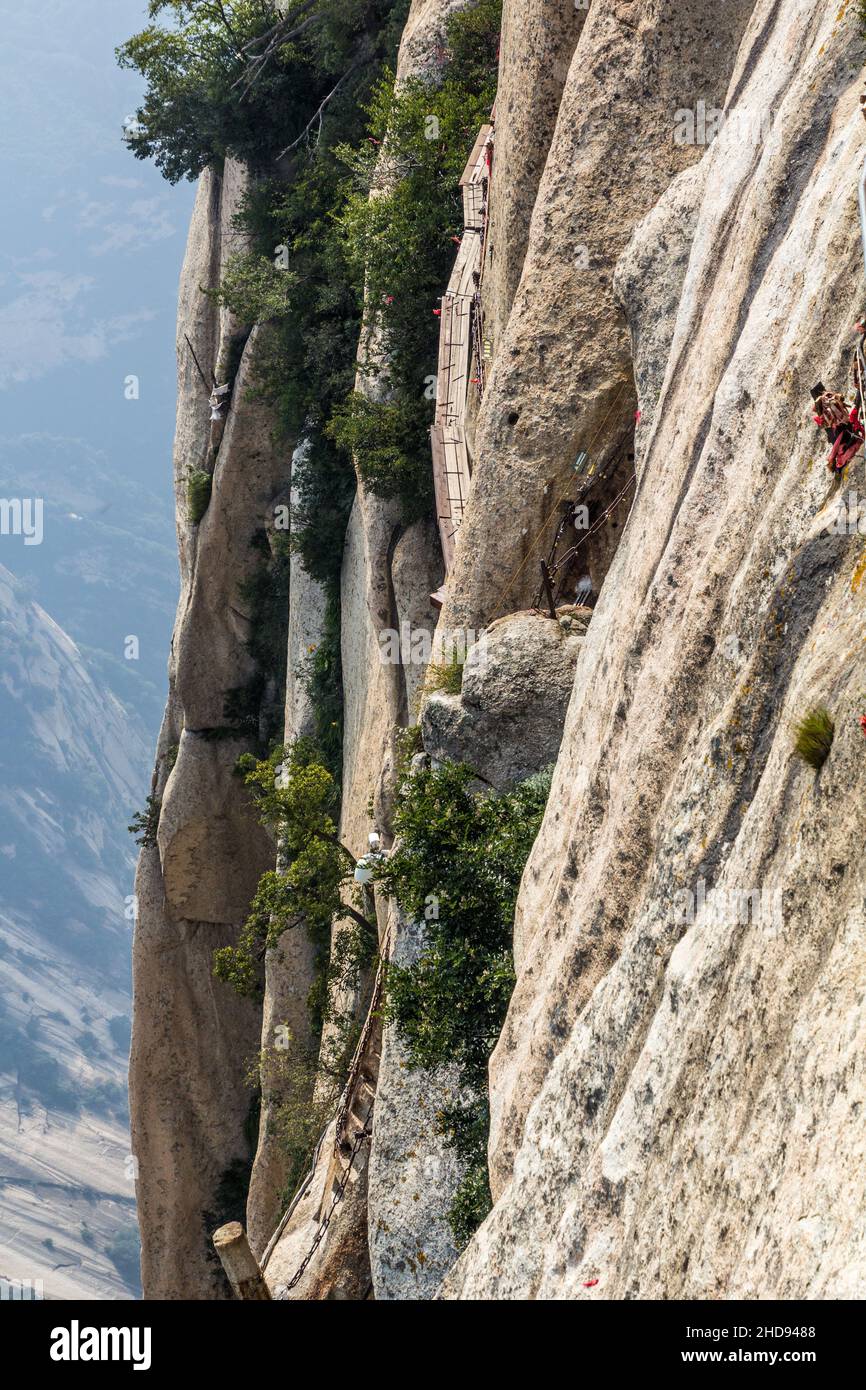 Narrow walkway at a sheer cliff at the South Peak of Hua Shan mountain ...