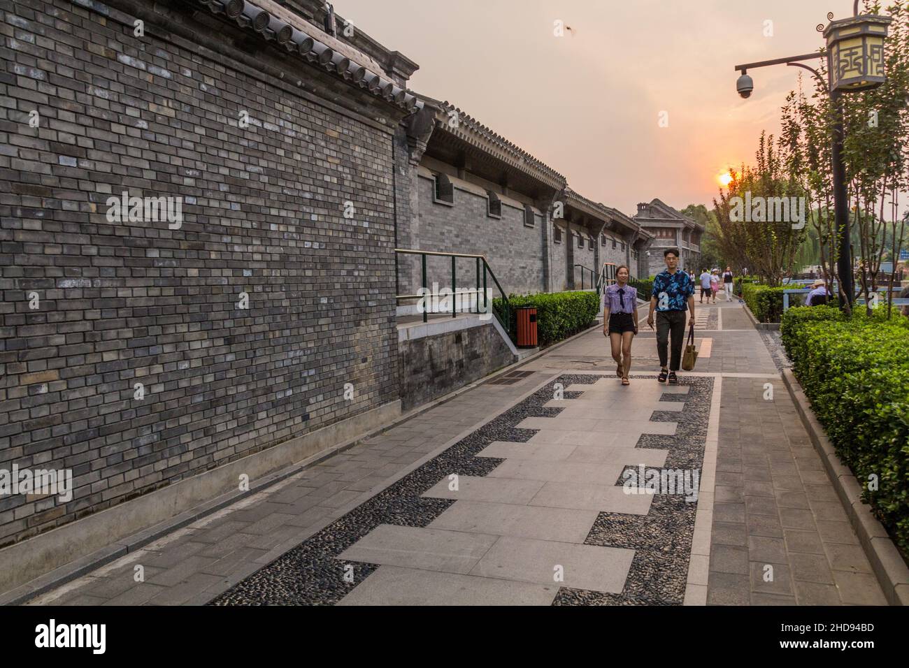 BEIJING, CHINA - AUGUST 26, 2018: People walk on a street in hutong ...