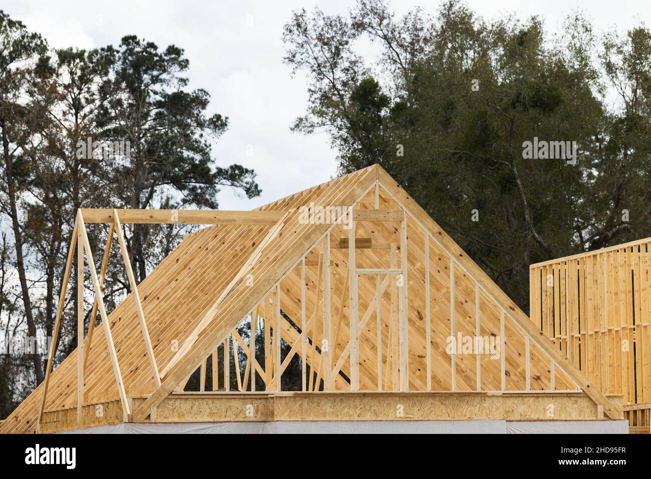 The top angled roof ridge area of a new construction house being built ...