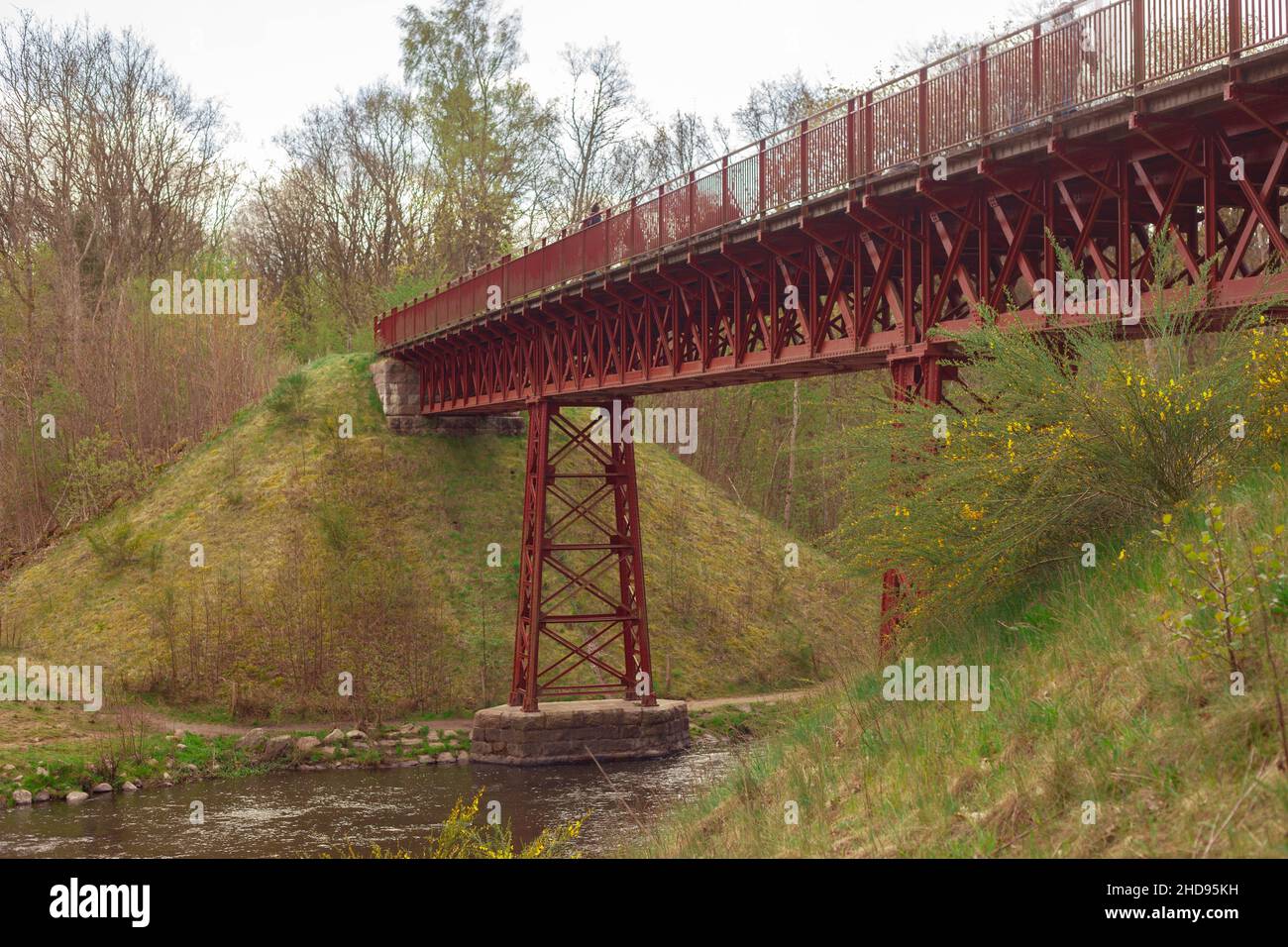 View of a red railway bridge above the river Stock Photo - Alamy