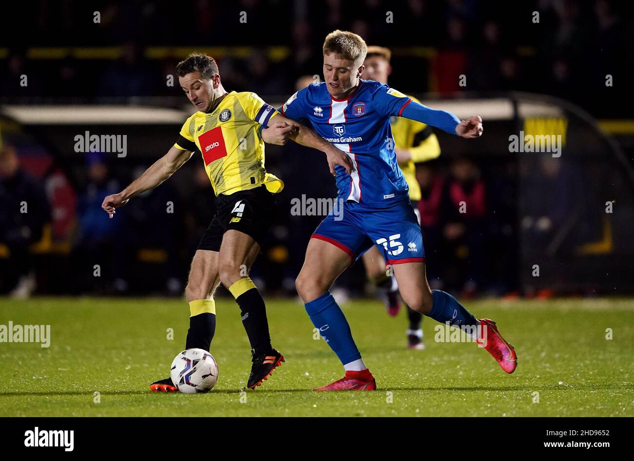 Harrogate Town's Joshua Falkingham (left) and Carlisle United's Sam ...