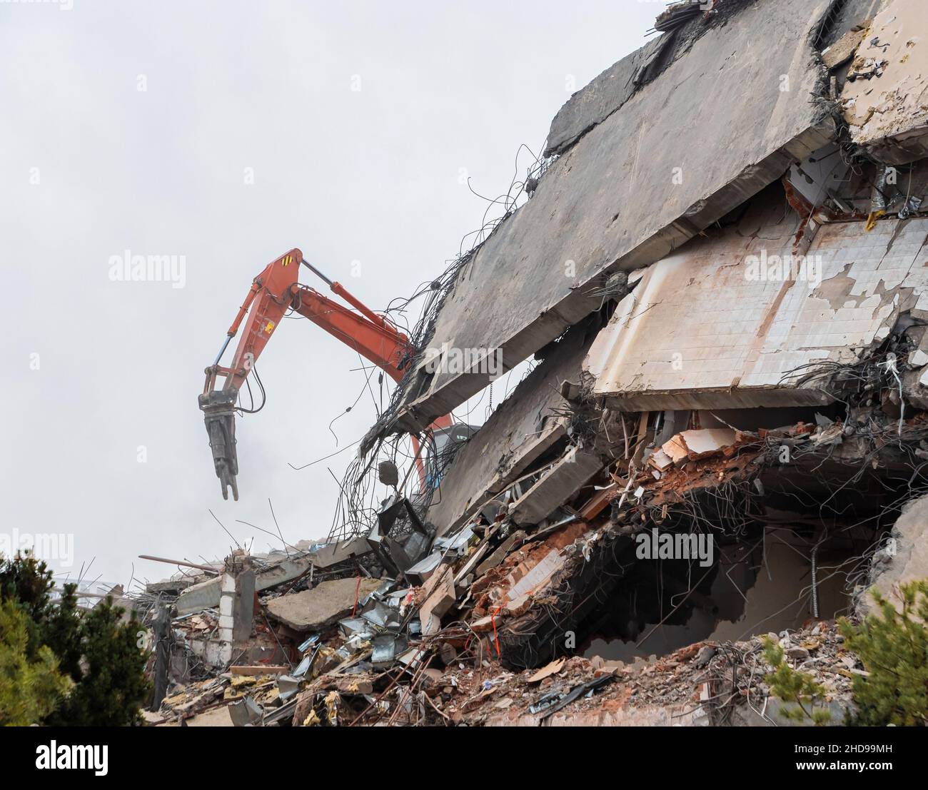 Heavy equipment being used to tear tearing down building construction ...