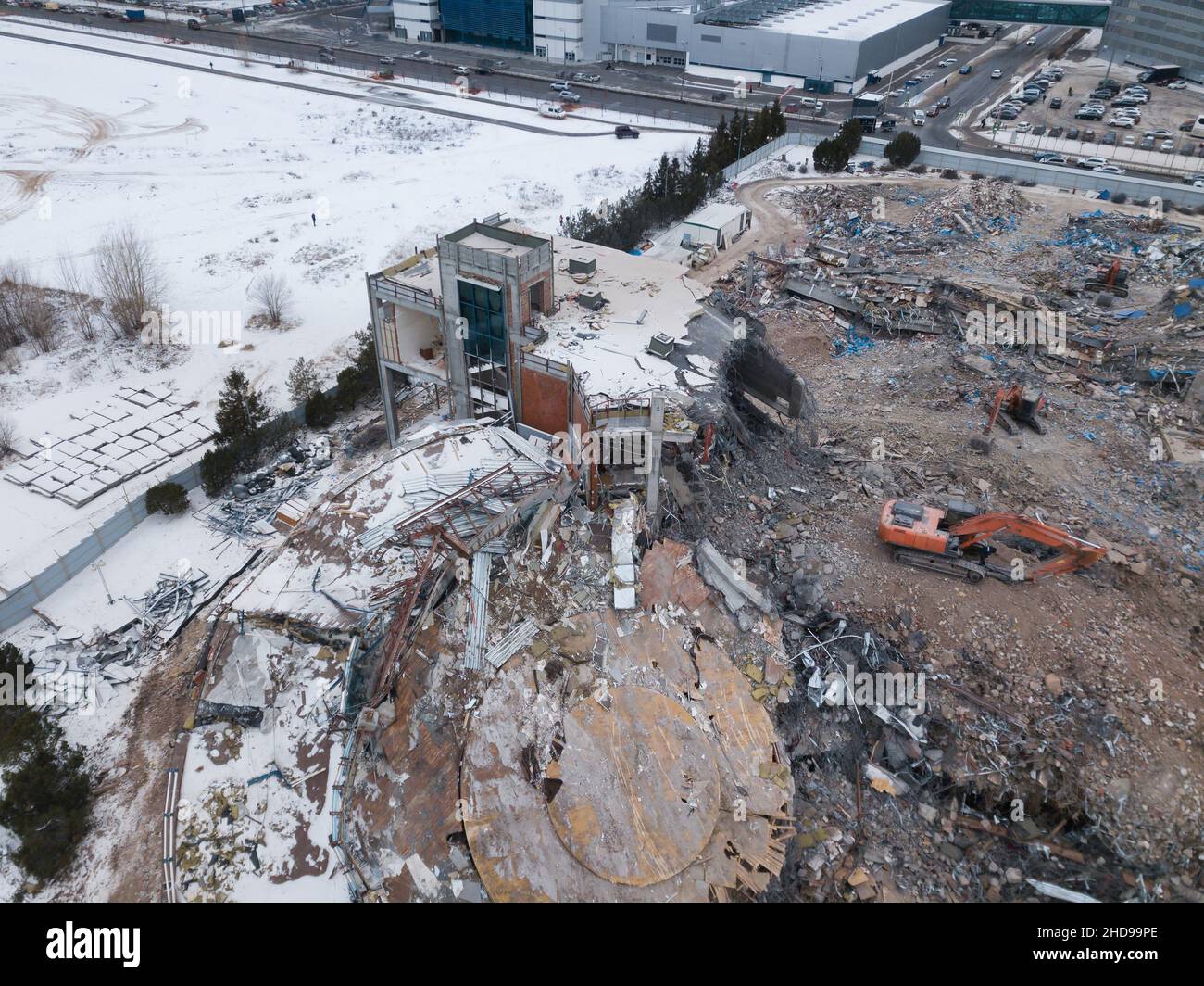 Heavy equipment being used to tear tearing down building construction ...