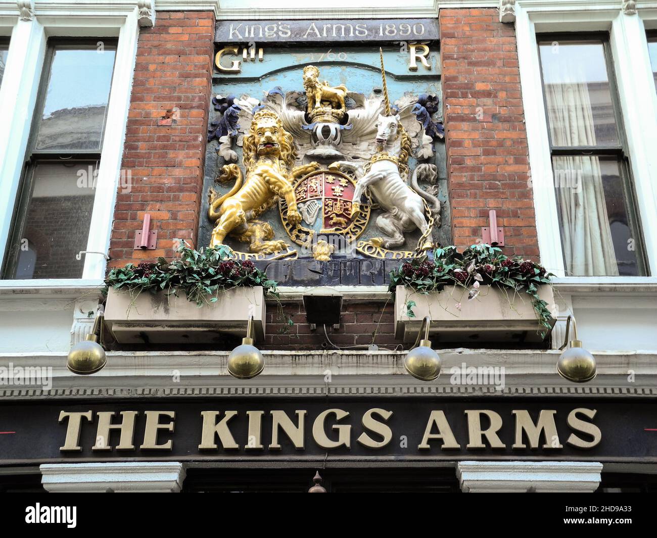 A lion and a unicorn on the royal coat of arms above the King’s Arms ...