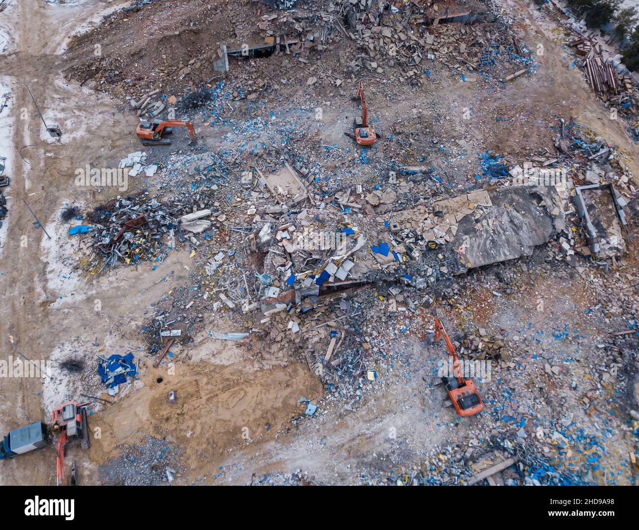 Heavy equipment being used to tear tearing down building construction ...