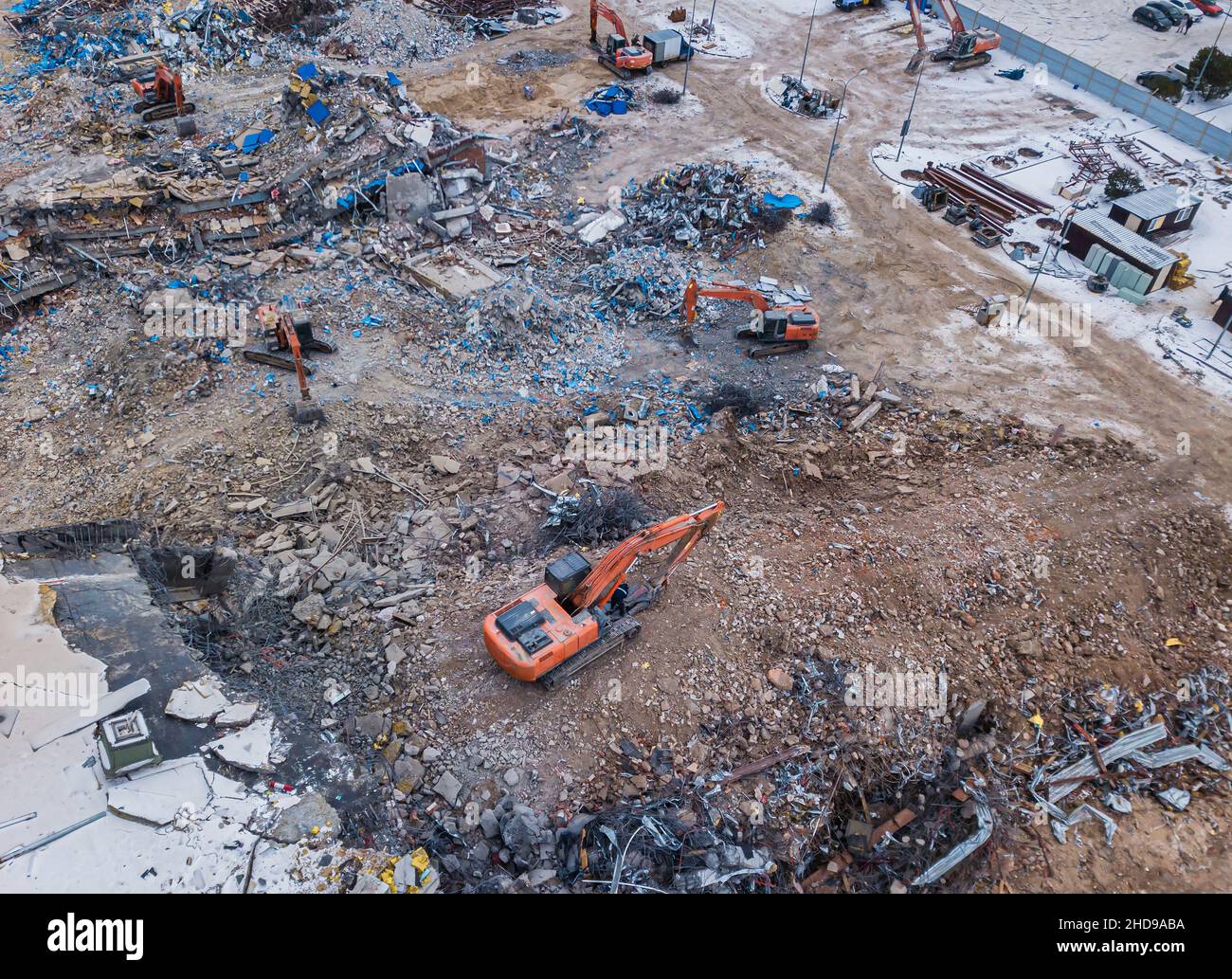 Heavy equipment being used to tear tearing down building construction ...