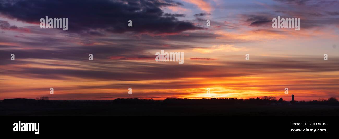 A colorful sunset sky on the prairies near Winkler, Manitoba, Canada ...