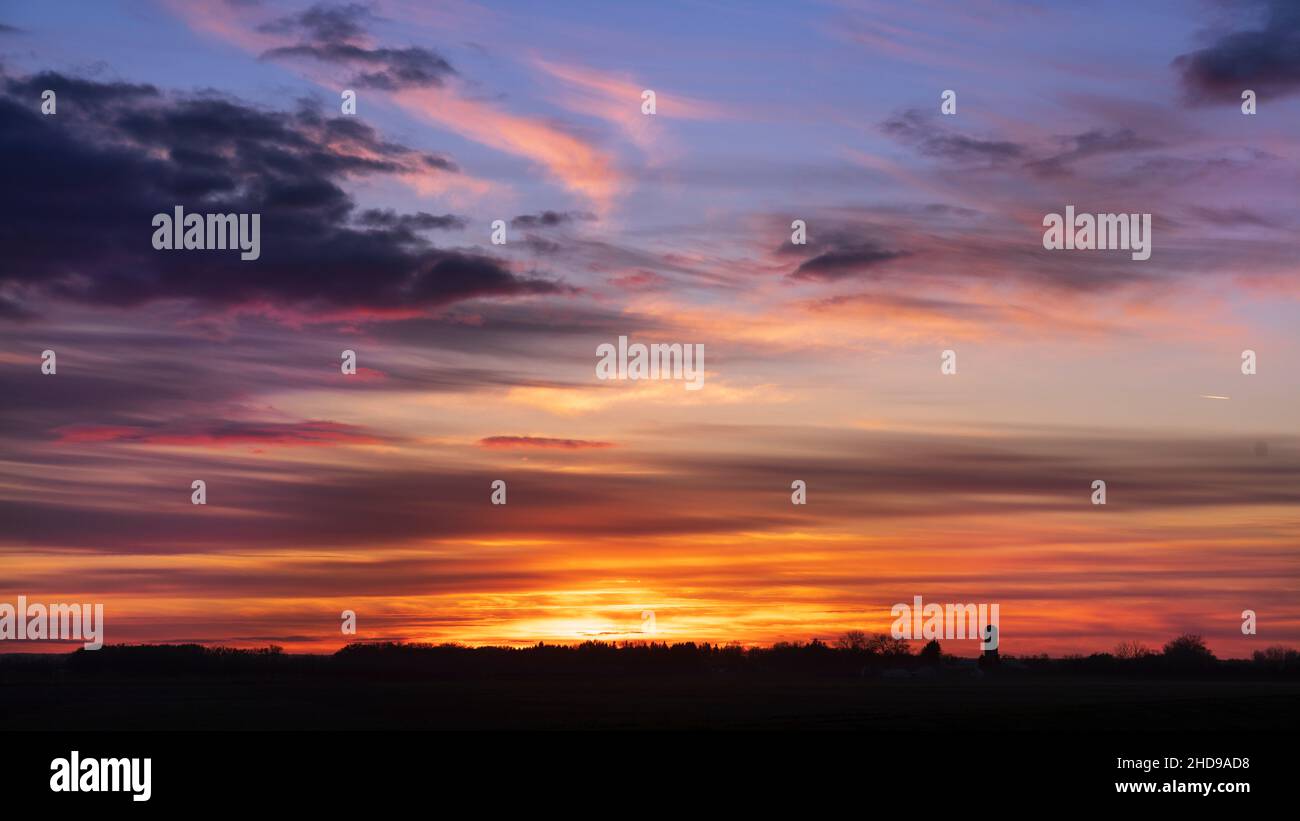 A colorful sunset sky on the prairies near Winkler, Manitoba, Canada ...