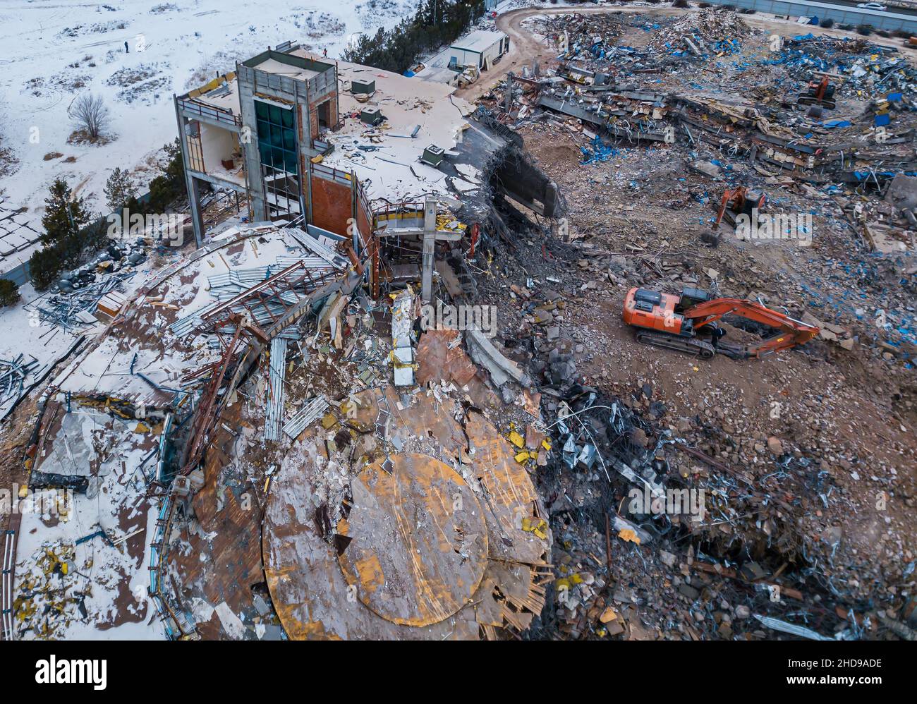 Heavy equipment being used to tear tearing down building construction ...