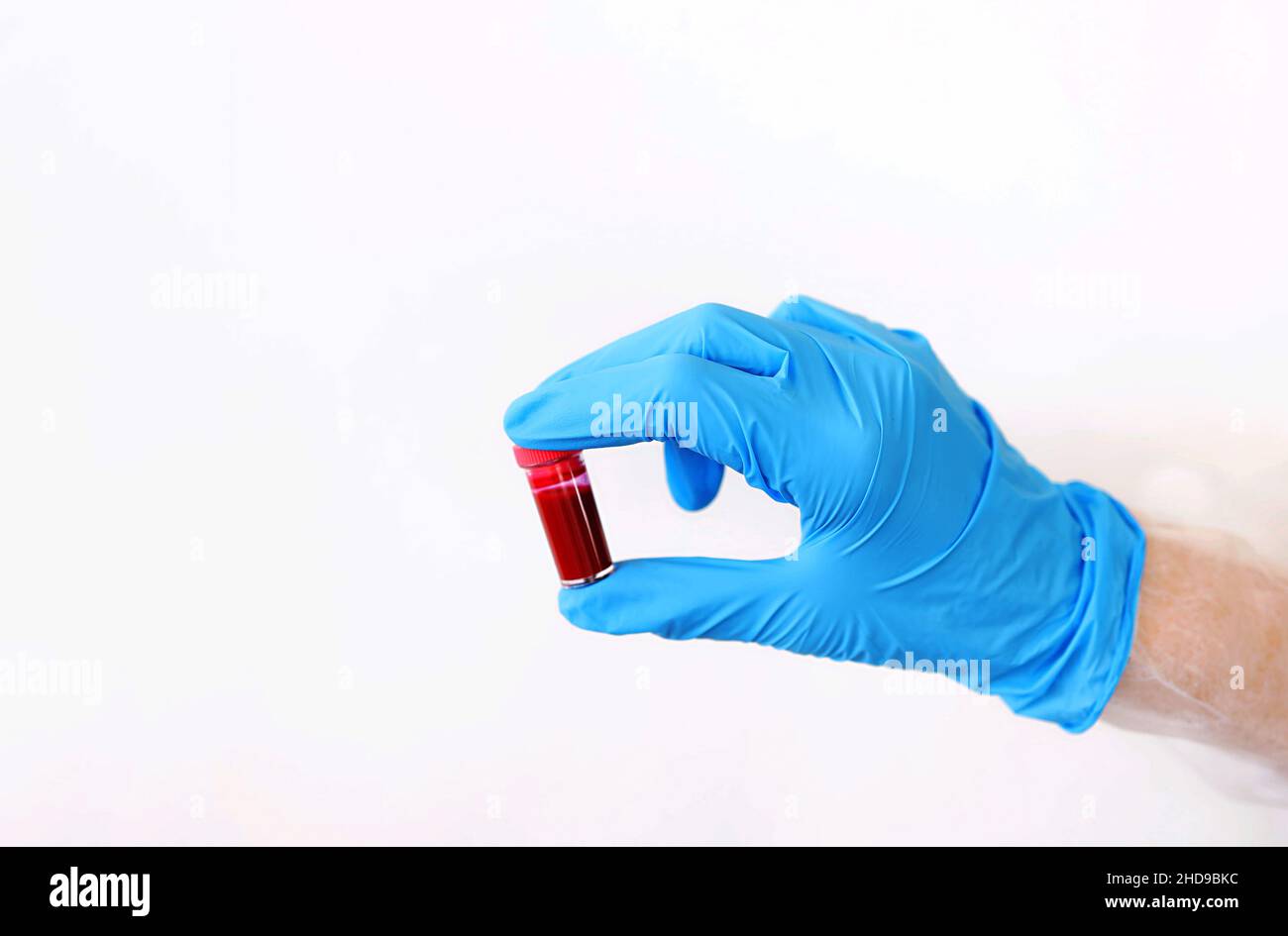 Doctor's hand holding test tube with blood sample for testing. blood ...