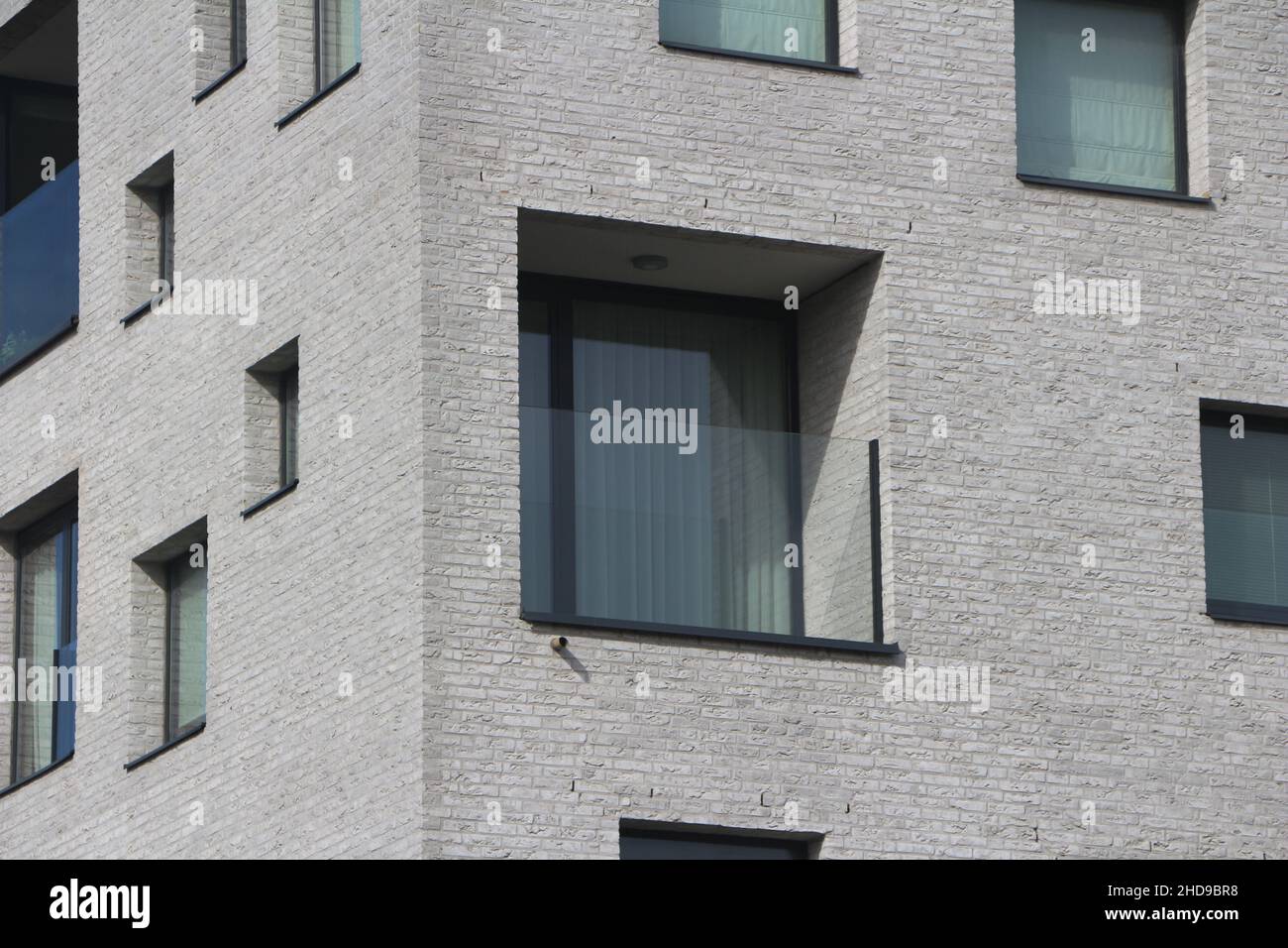 Brick white building with many windows Stock Photo - Alamy