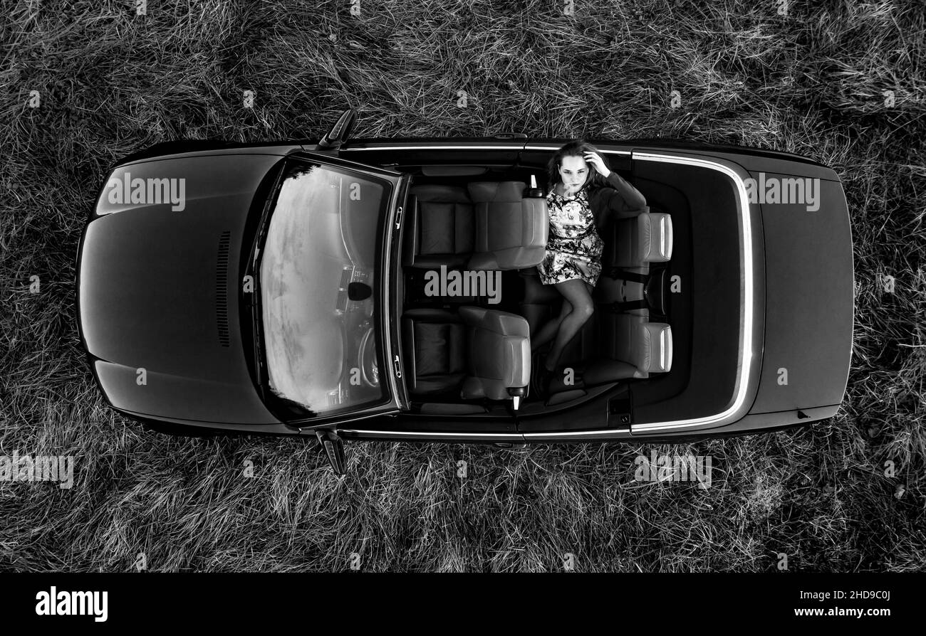 Beautiful girl and retro convertible, top view with drone, geometry and ...