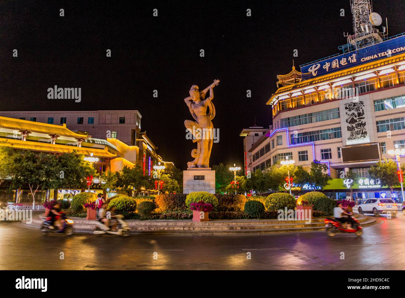 DUNHUANG, CHINA - AUGUST 19, 2018: Evening view of flying Apsara statue ...