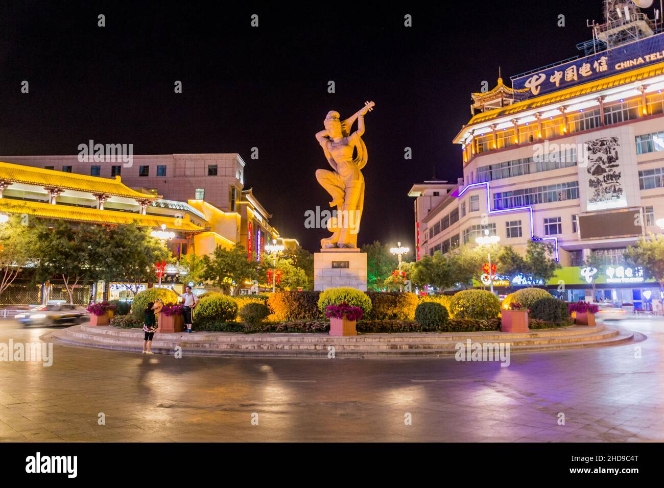 DUNHUANG, CHINA - AUGUST 19, 2018: Evening view of flying Apsara statue ...