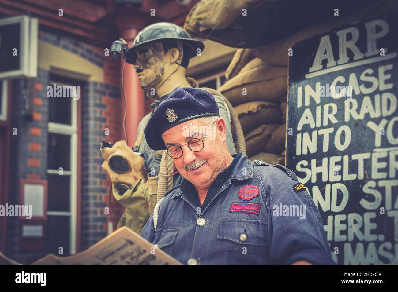 Close up of wartime, 1940 ARP warden (air raid precaution) reading ...
