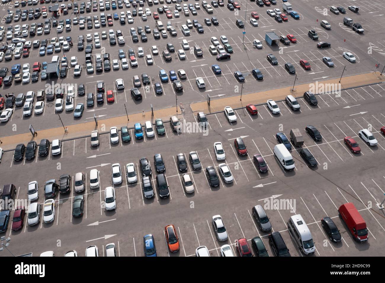 Parking lot with many parked cars at business center or mall, aerial ...