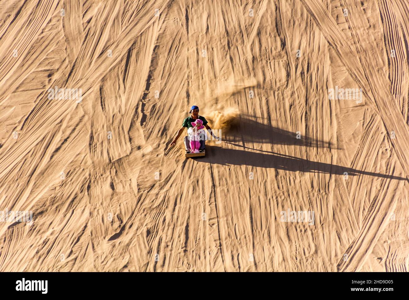 DUNHUANG, CHINA - AUGUST 21, 2018: Sand sledding at Singing Sands Dune ...