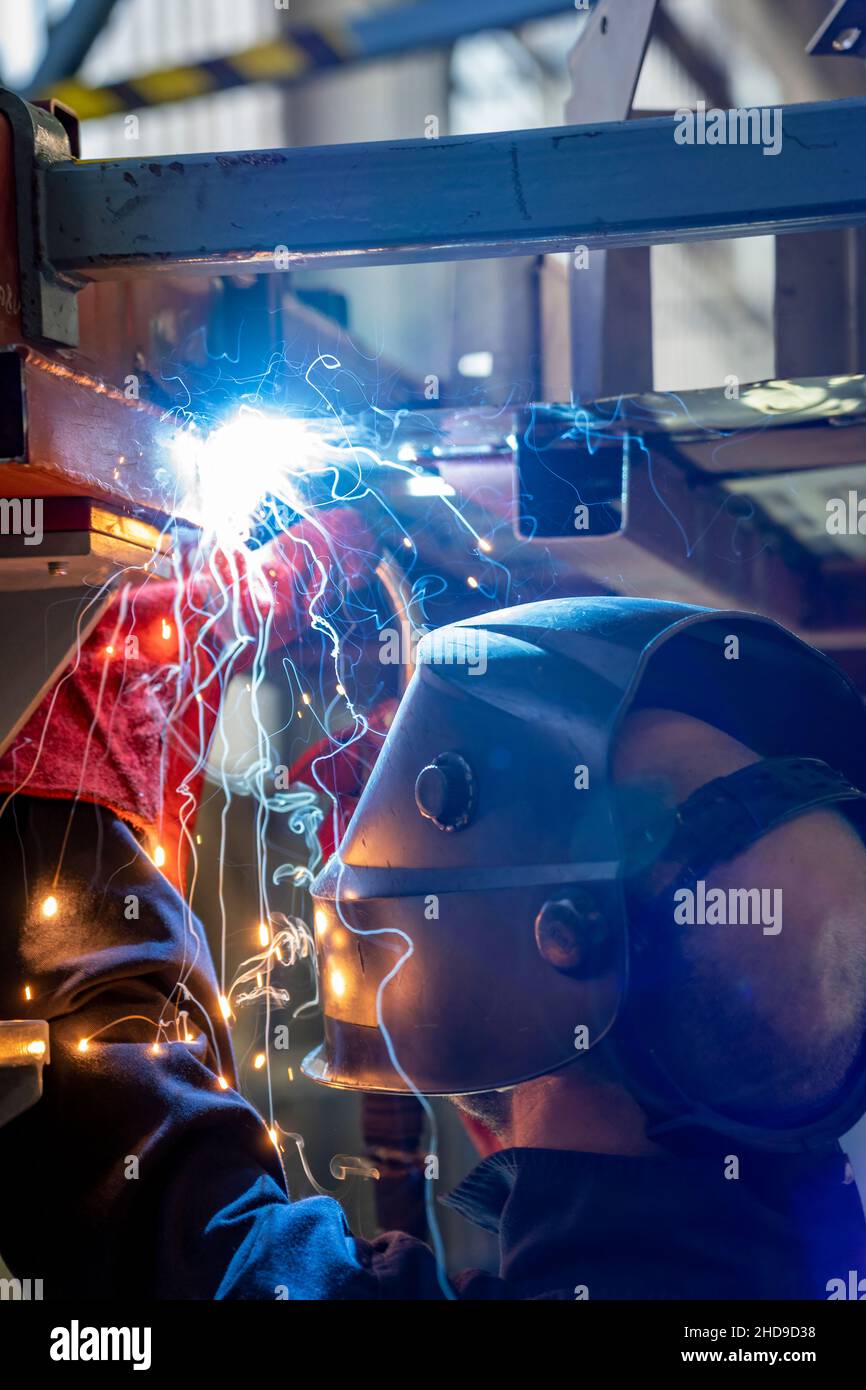 Worker With Welding Helmet And Protective Workwear Welding Train ...