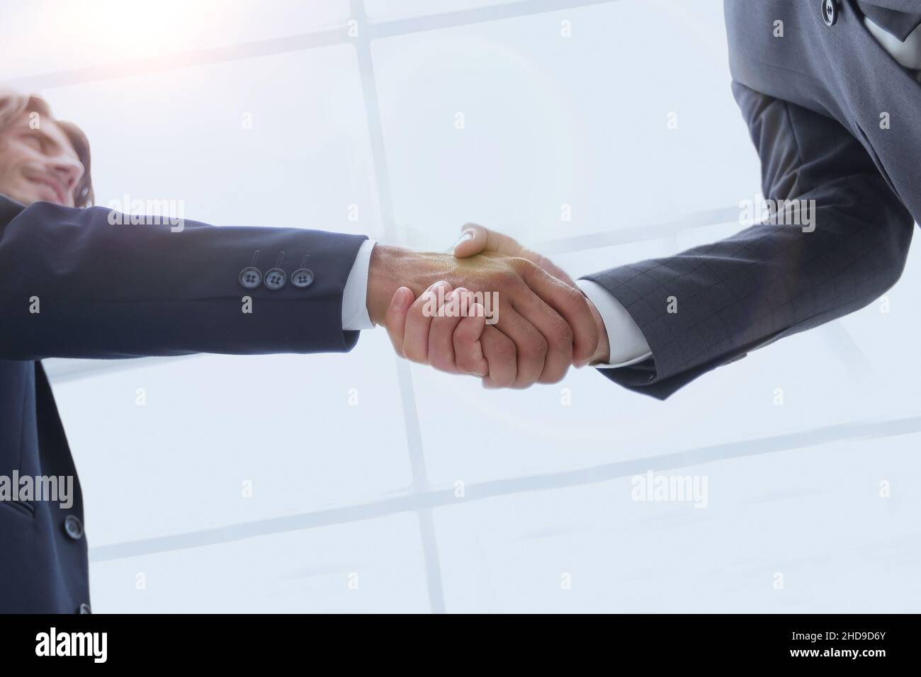 bottom view of two men shaking hands while standing Stock Photo - Alamy
