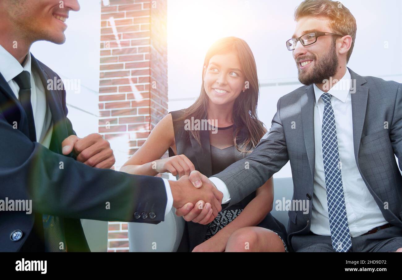 handshake Manager and the client at a meeting in the office lobby Stock ...
