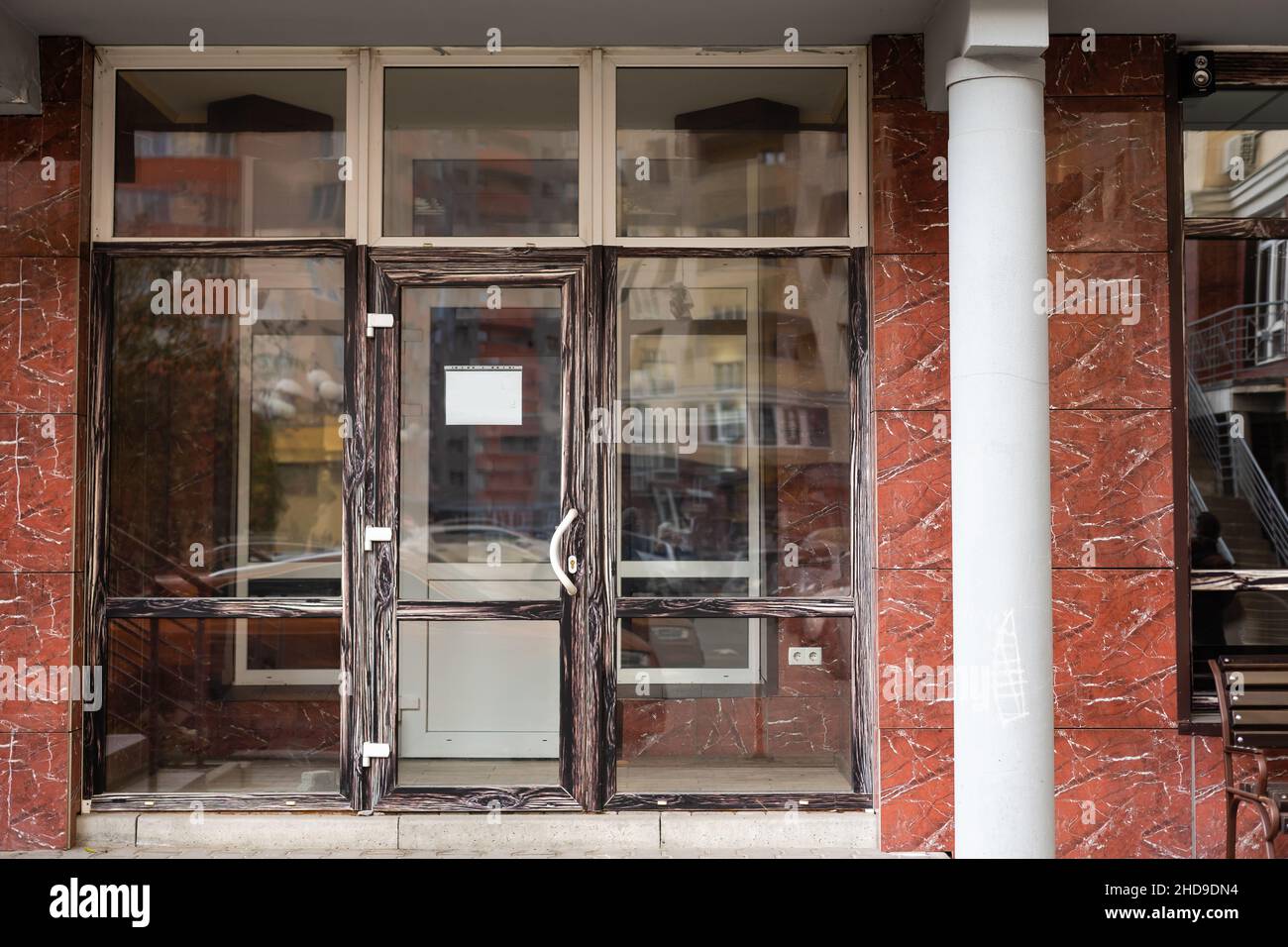 Outside solid glass door with building exterior Stock Photo - Alamy
