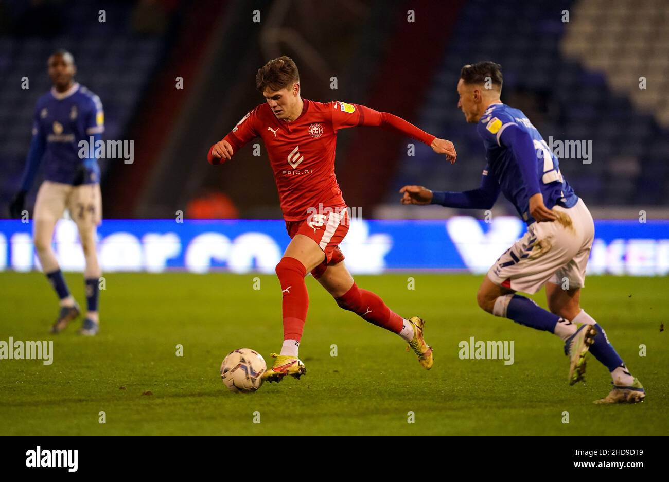 Oldham Athletic's Jamie Hopcutt and Wigan Athletic's Tom Pearce (left ...