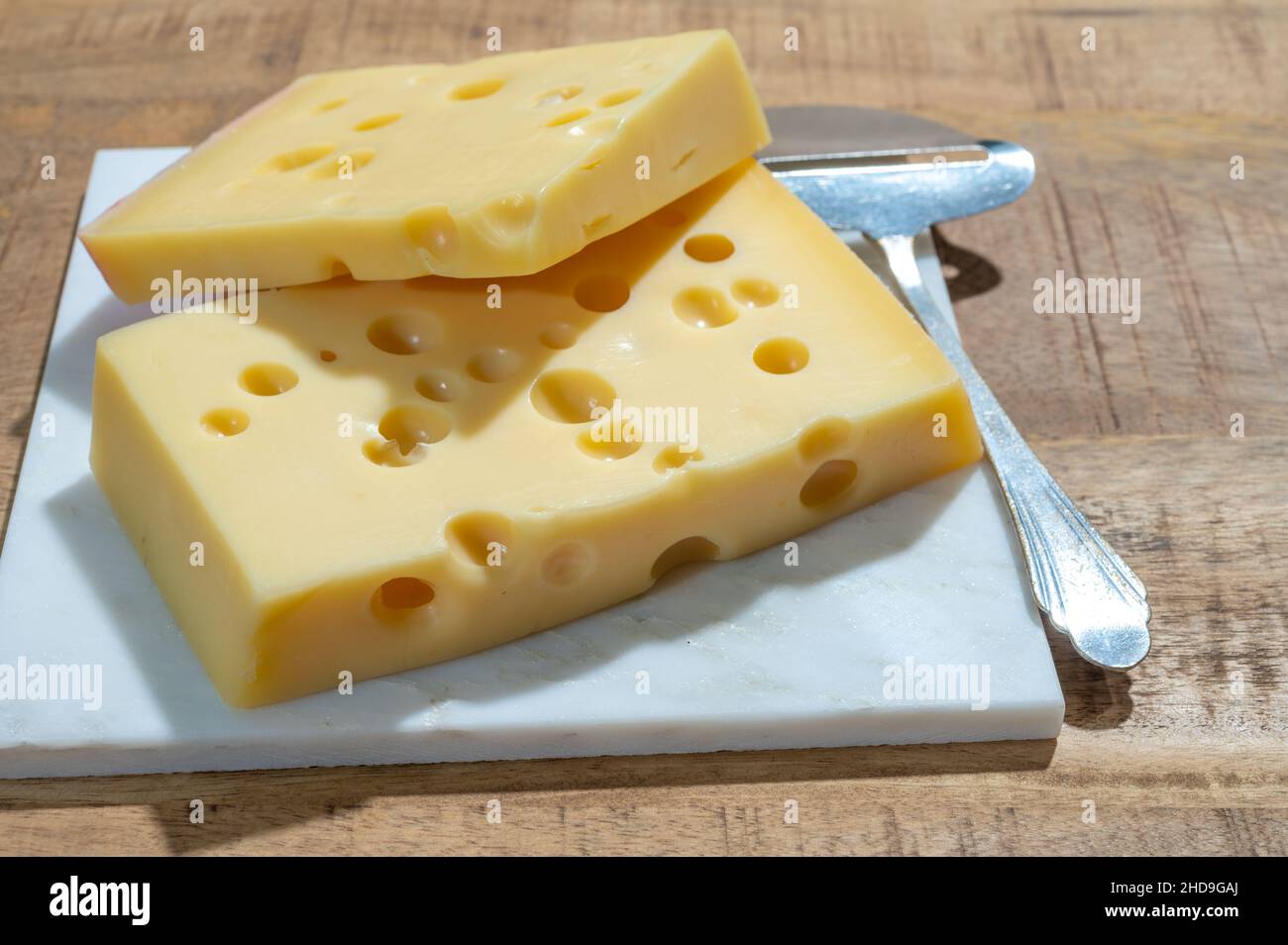 Cheese collection, blocks of French emmentaler cheese with many round ...