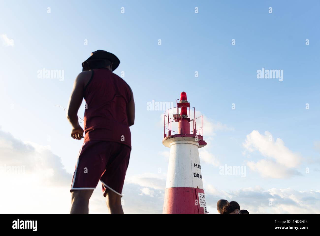Silhouette of people at sunset fishing with fishing rod on Monte Serrat ...
