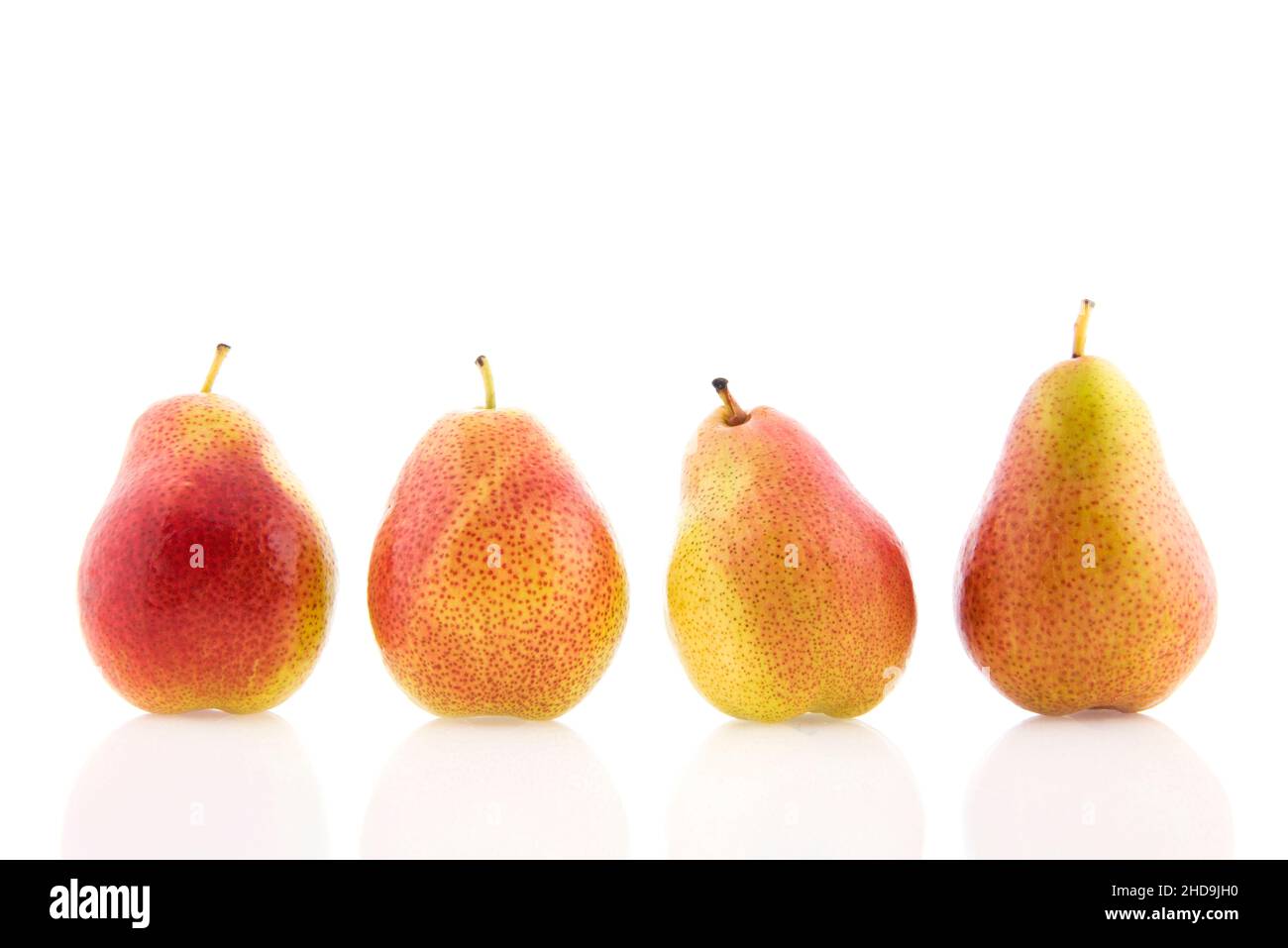 Row red and yellow pears isolated over white background Stock Photo - Alamy