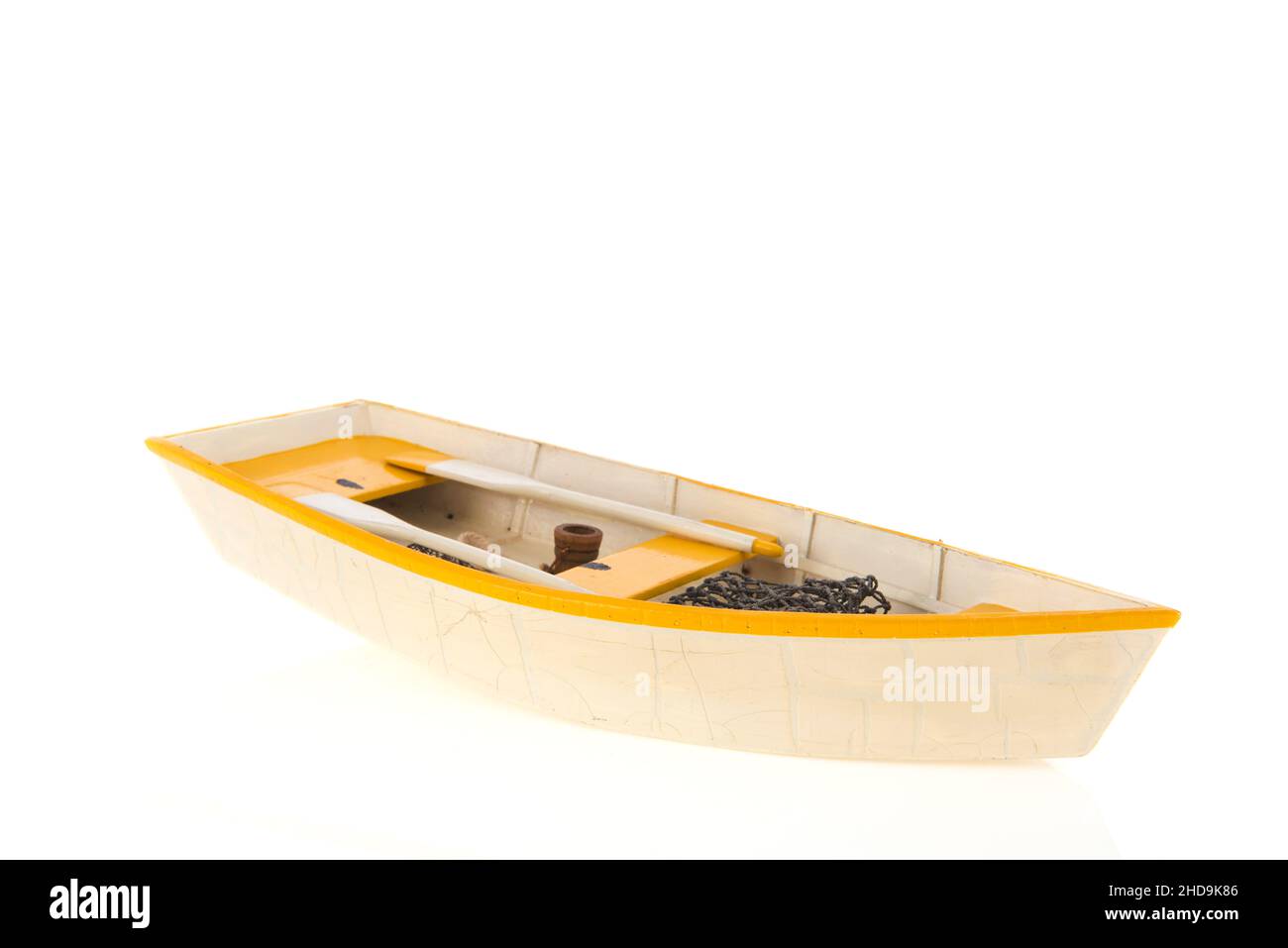 Wooden yellow row boat isolated over white background Stock Photo - Alamy