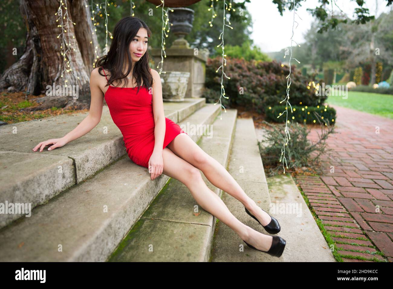 Young East Asian Woman in Red Party/Holiday Dress Lounging on Steps ...