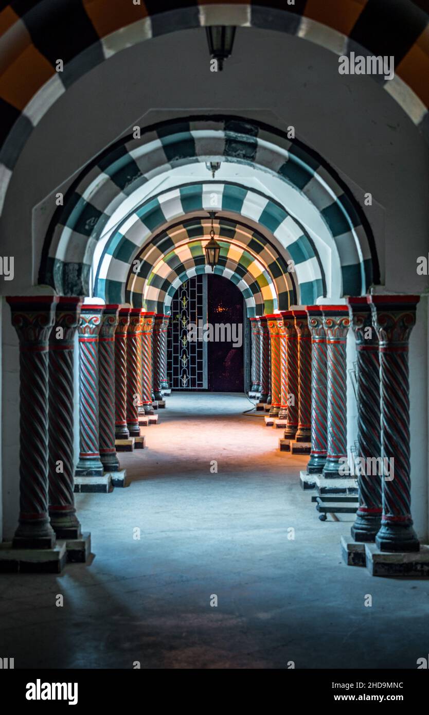 Vertical shot of a night photography of a corridor with painted arc ...