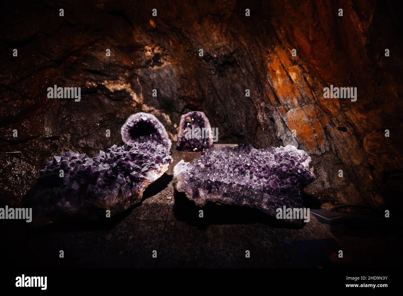 violet multiple magic crystals inside mountain illuminated by ...