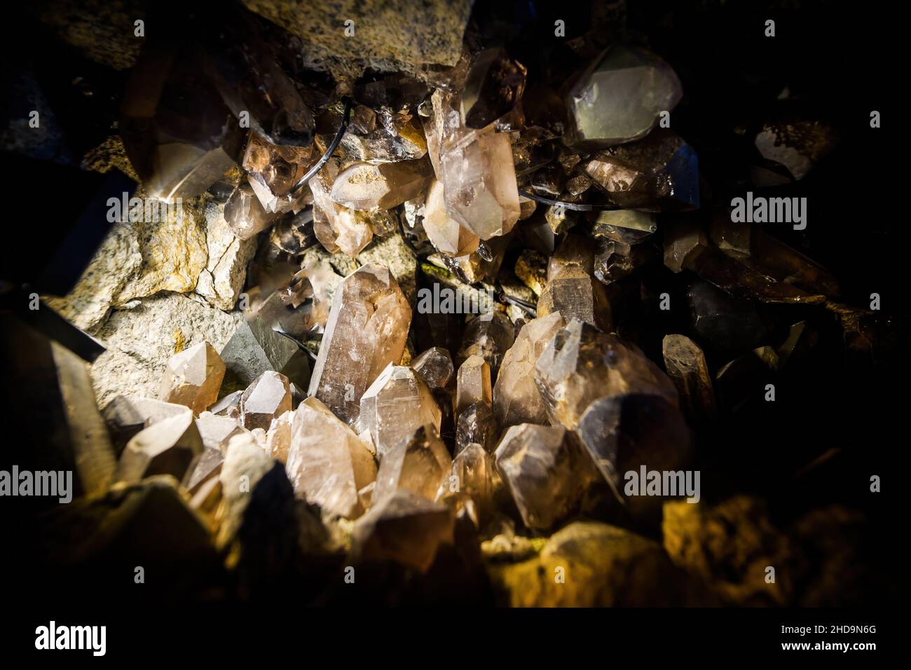 Crystals inside mountain illuminated by speleological caving Stock ...