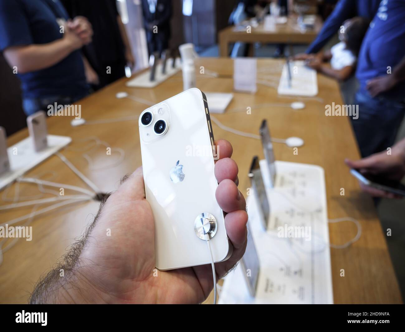 Male hand holding new silver iPhone 13 smartphone model by Apple ...