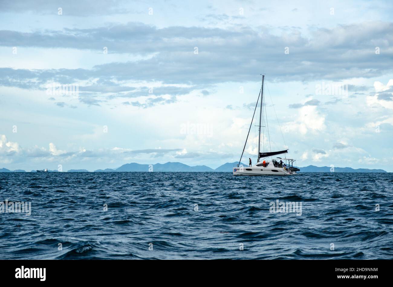 Sailboat cruising the sea near Phuket, Thailand under a cloudy sky Stock Photo - Alamy