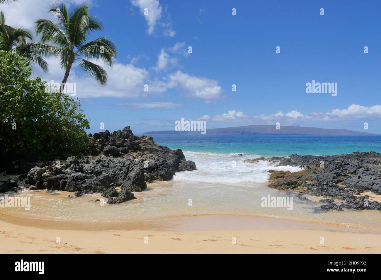 Beautiful secluded beach in Maui Hawaii with an island in the ...