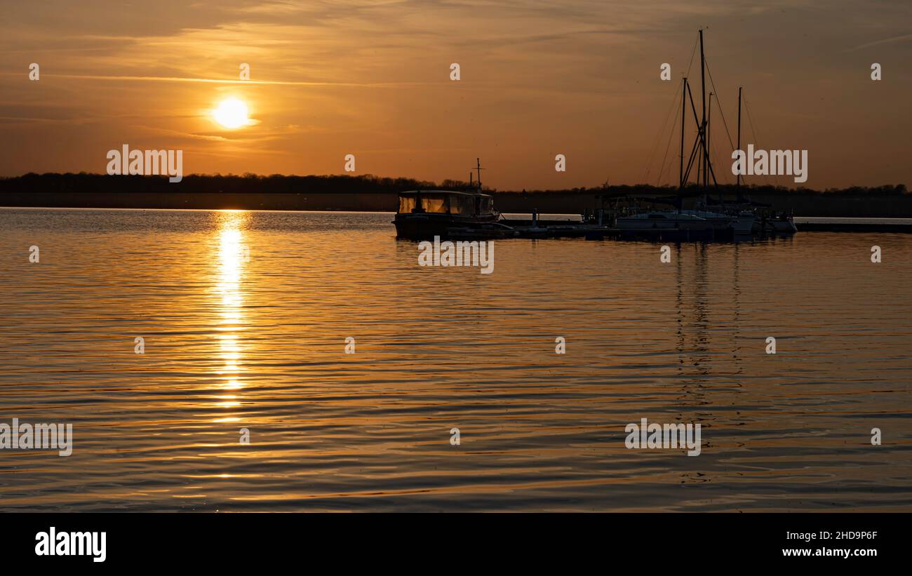 Ship in the water with a reflection of a sunlight Stock Photo - Alamy