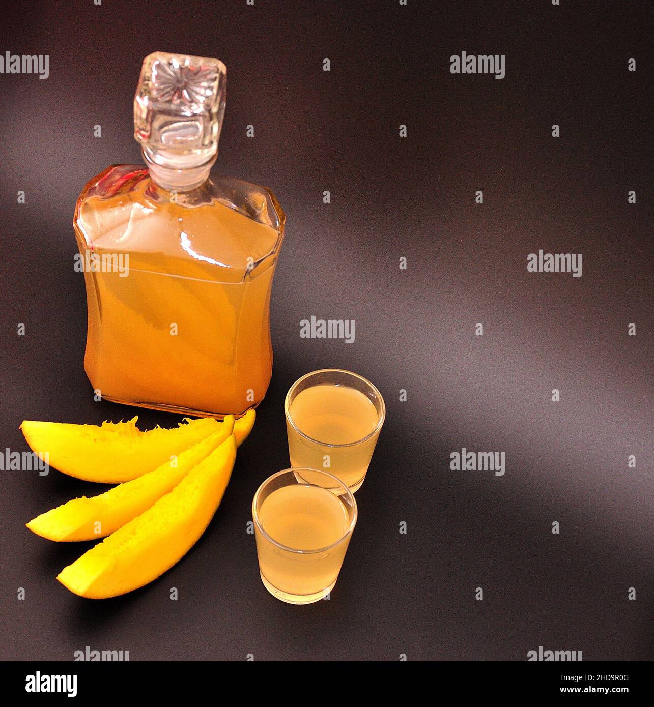 Banana liqueur, strong homemade alcohol and a branch of ripe fruits on ...