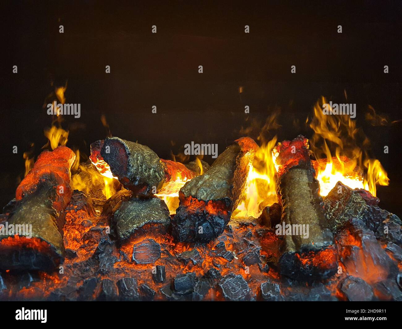 Pile of wood burning in the fireplace Stock Photo - Alamy