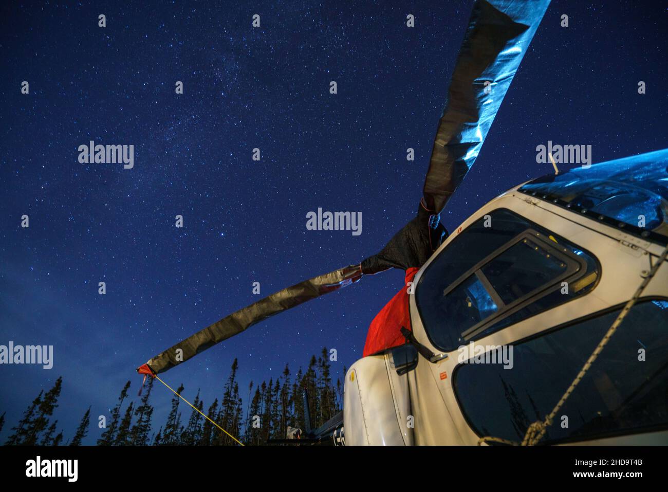 Helicopter in a forest under a starry night sky Stock Photo - Alamy