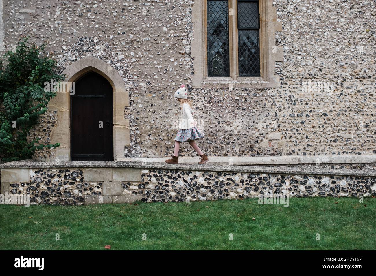 Girl walking along wall hi-res stock photography and images - Alamy