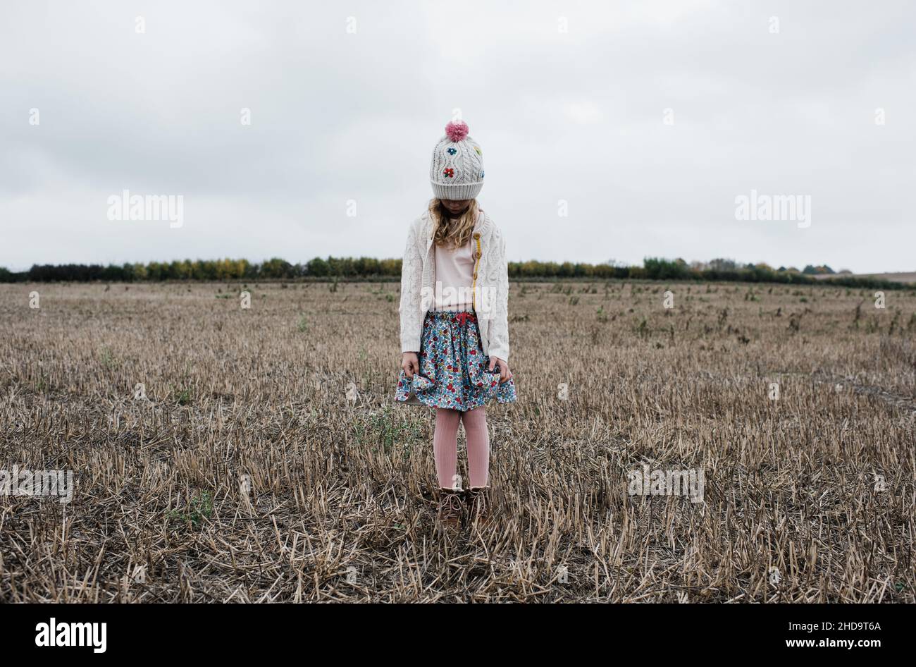 child looking sad whilst outside playing in a field Stock Photo - Alamy